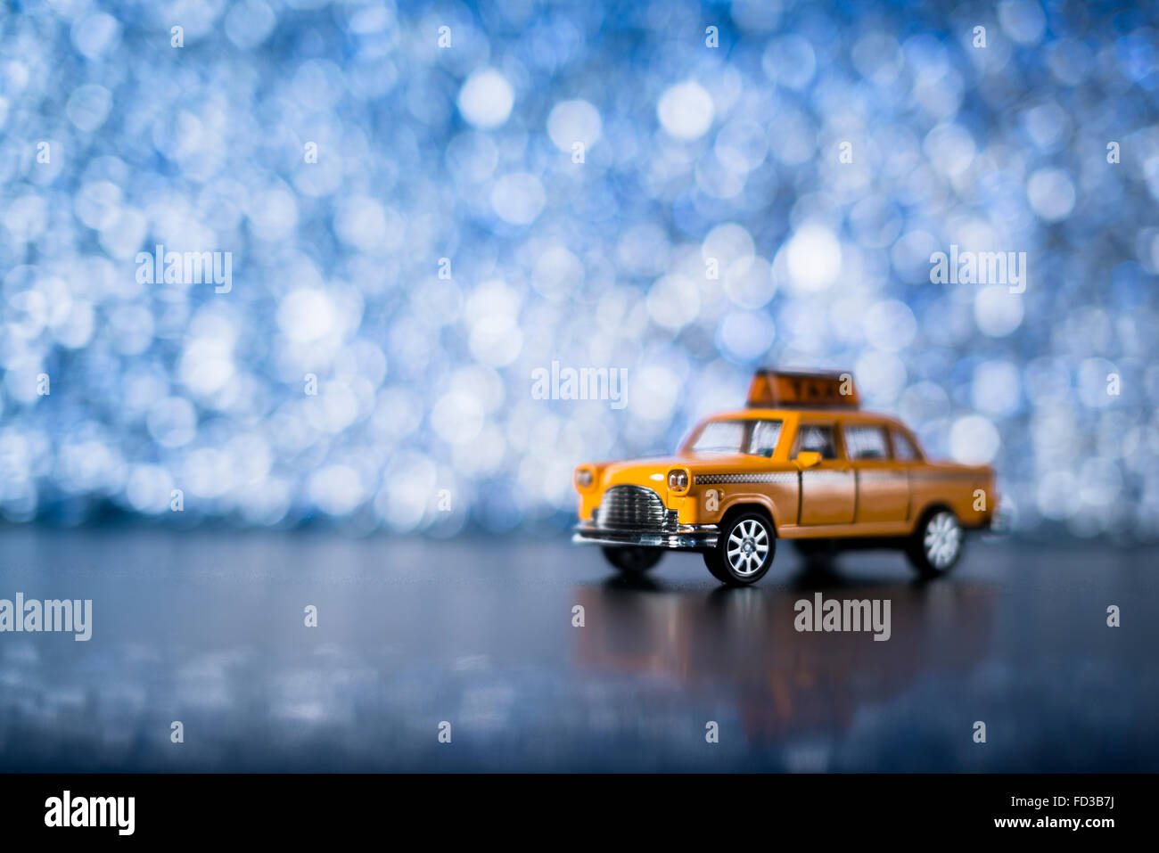 Yellow cab on a Turquoise bokeh background Stock Photo - Alamy