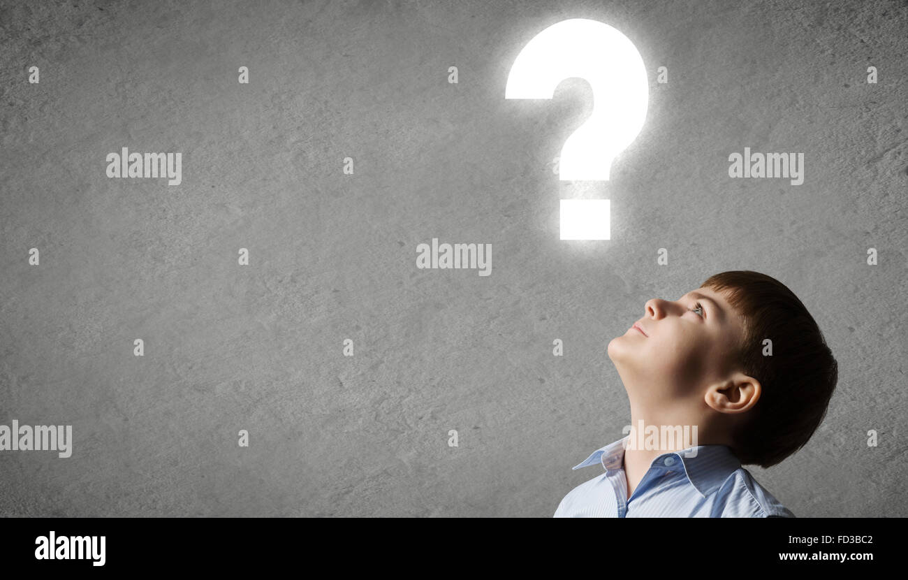 Young boy of school age looking question mark Stock Photo - Alamy