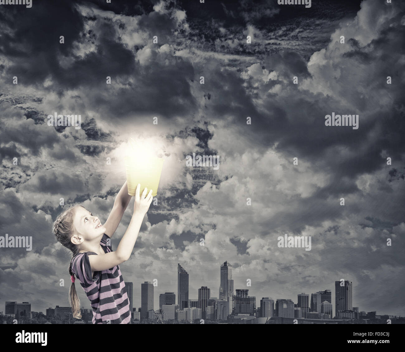 Cute girl with bucket trying to catch the sun Stock Photo - Alamy