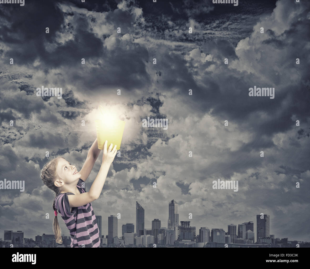 Cute girl with bucket trying to catch the sun Stock Photo - Alamy