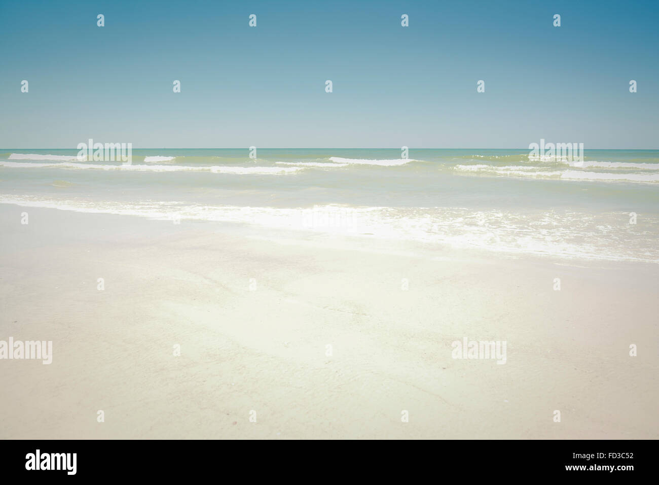 An empty wide angle landscape view of an idyllic white sandy beach with ...