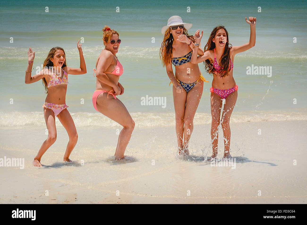 Four jubilant women in bikinis celebrate with laughter and exuberance ... Four jubilant women in bikinis celebrate with laughter and exuberance ...