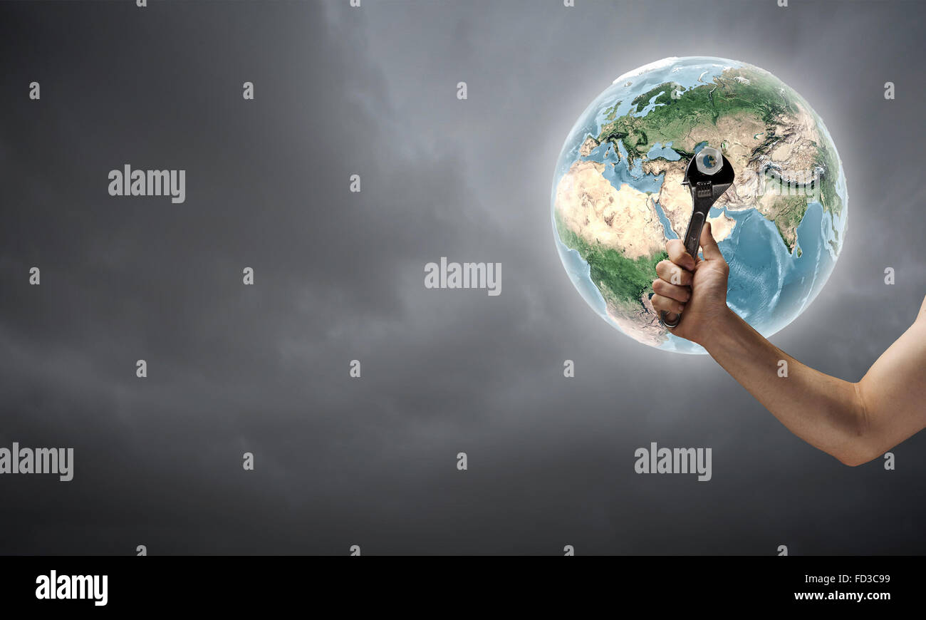 Close up of hand spinning nut on Earth planet. Elements of this image ...