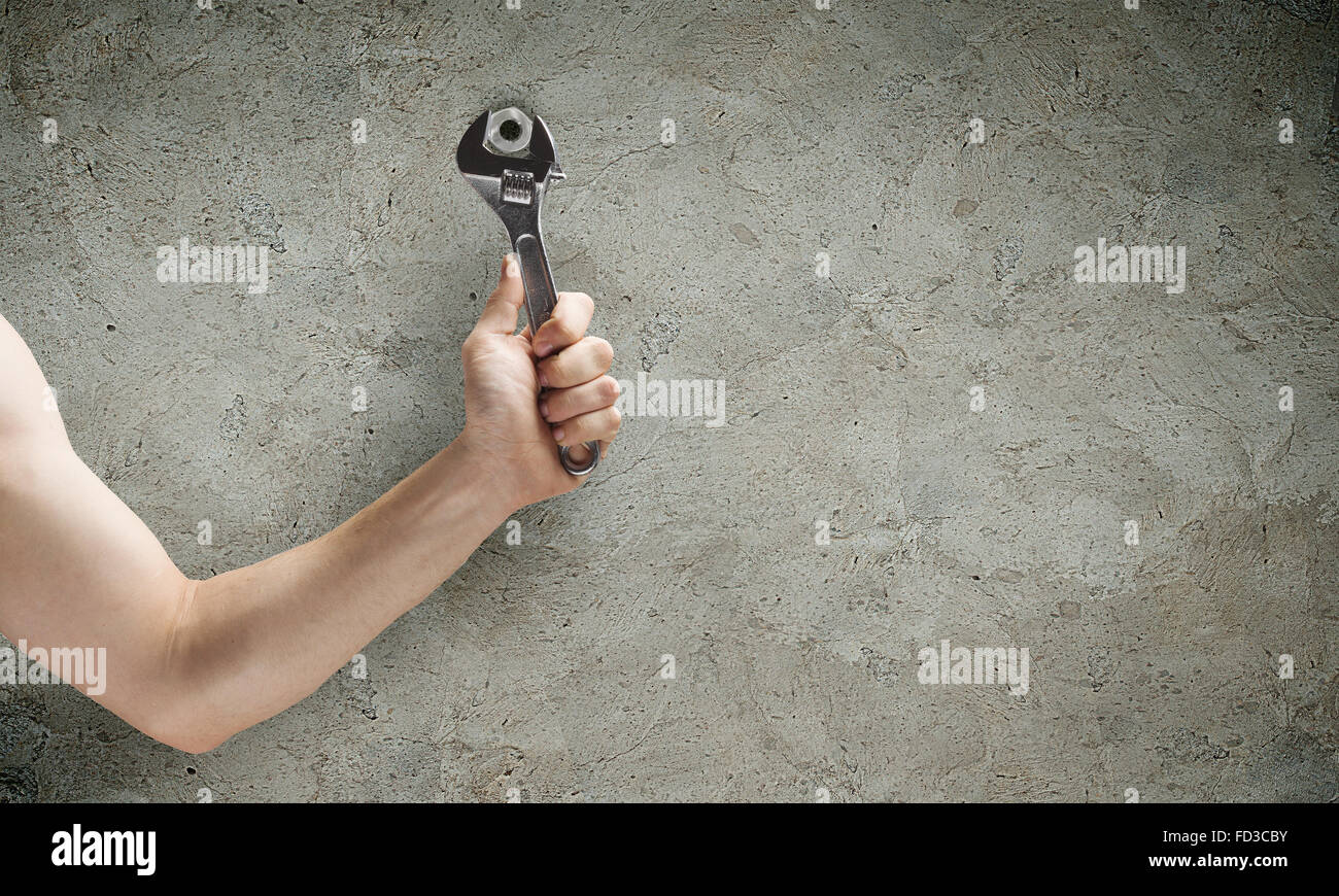 Close up of hand spinning nut with wrench Stock Photo - Alamy