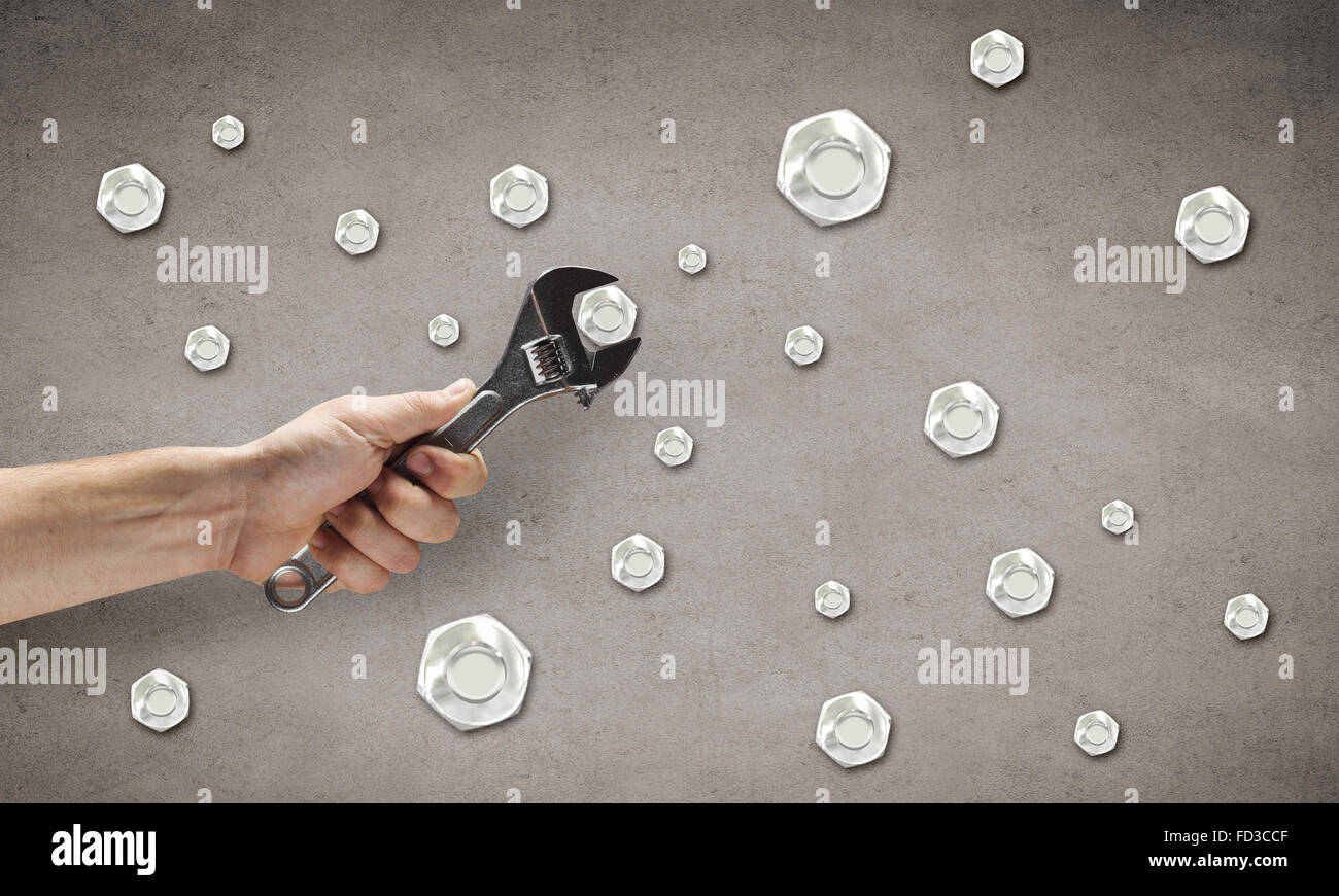 Close up of hand spinning nut with wrench Stock Photo - Alamy