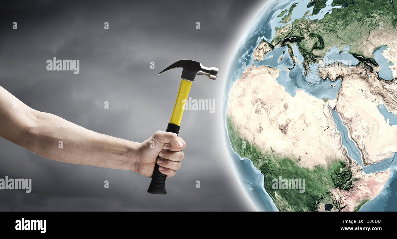 Close up of hammer in human hand hitting Earth planet. Elements of this ...
