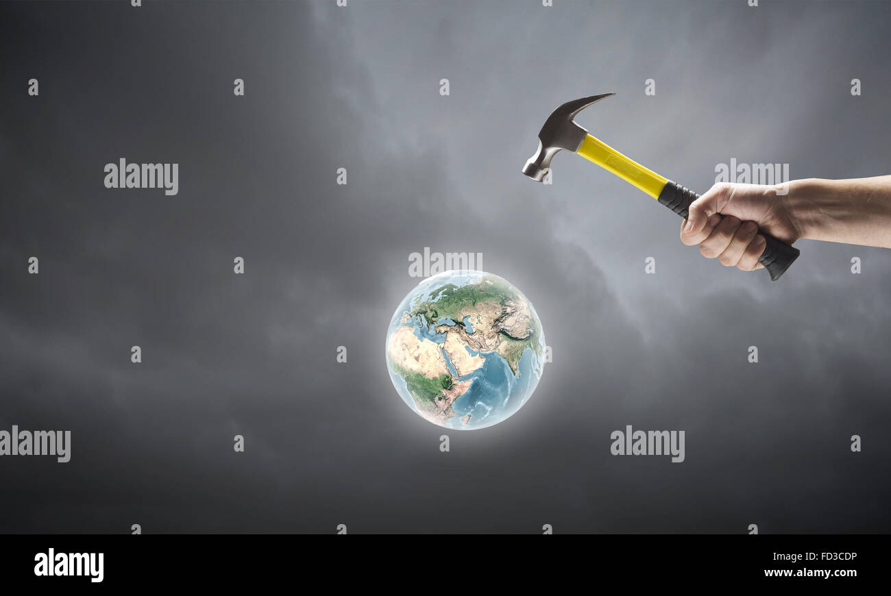 Close up of hammer in human hand hitting Earth planet. Elements of this ...