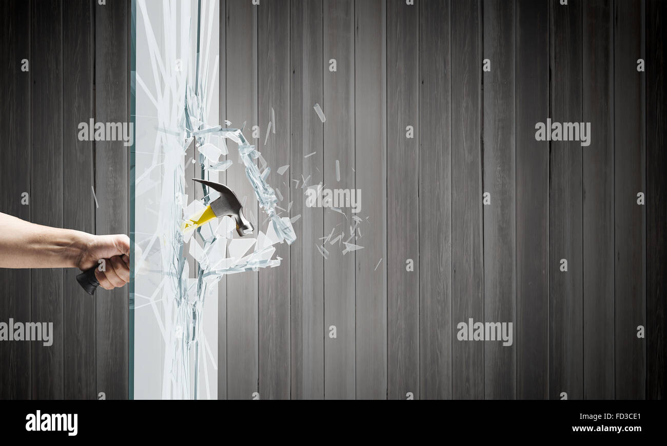 Close up of hammer in human hand breaking glass Stock Photo - Alamy