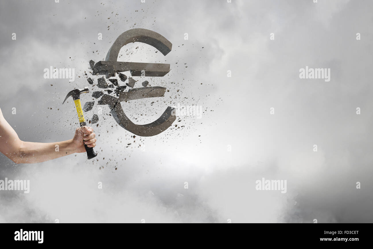 Close up of hammer in human hand breaking stone euro symbol Stock Photo ...
