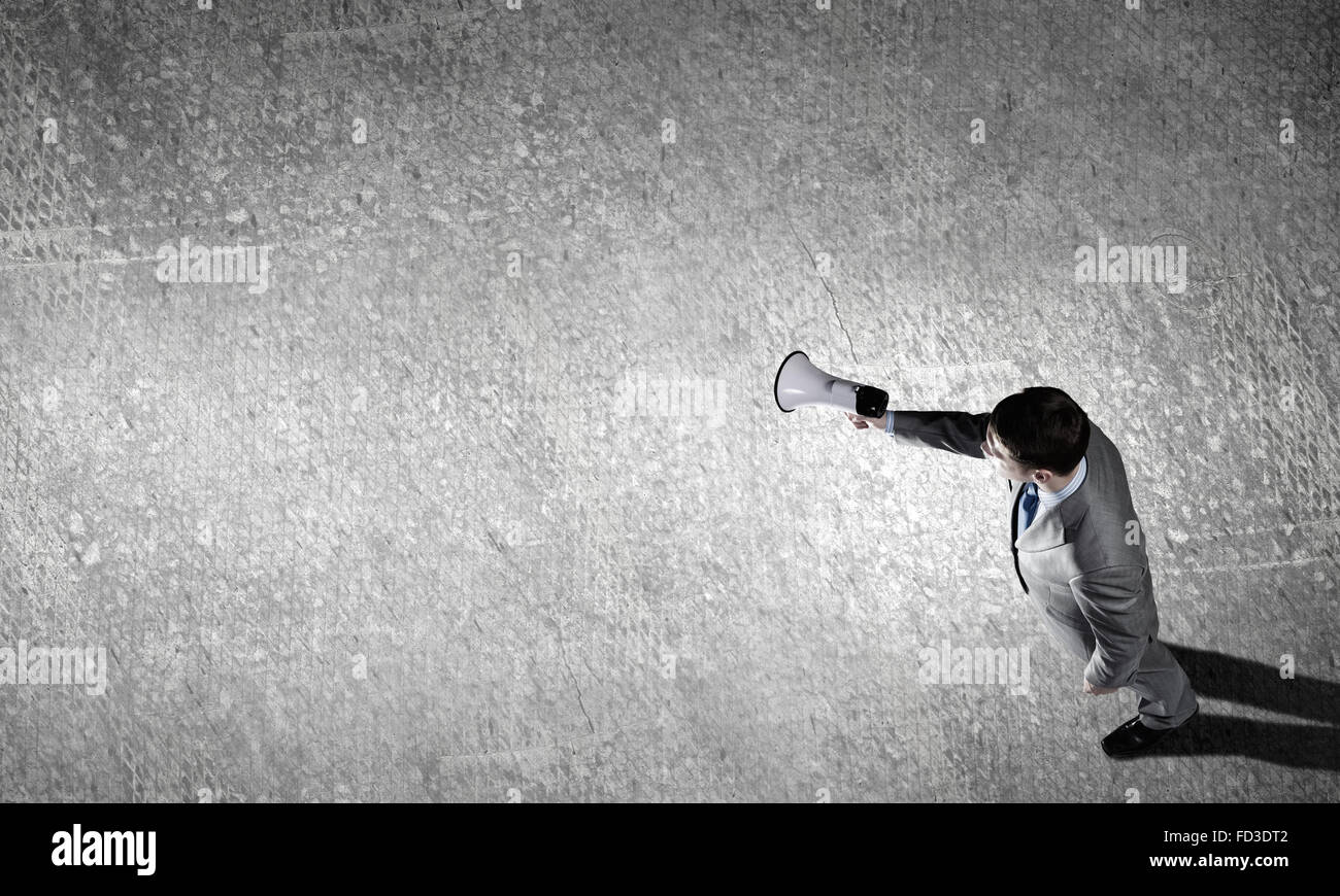 Top view of businessman screaming in megaphone Stock Photo - Alamy