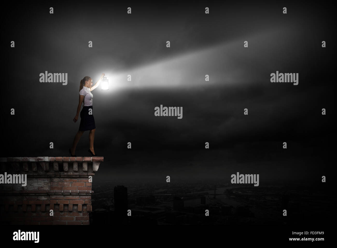 Young businesswoman walking in darkness with lantern in hand Stock ...