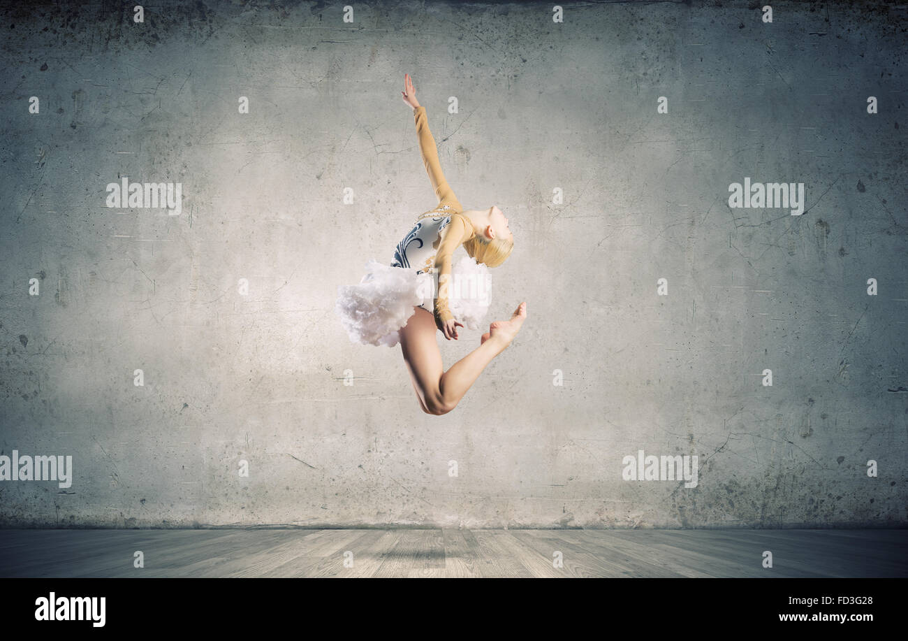 Young pretty ballerina girl making jump in dance Stock Photo - Alamy
