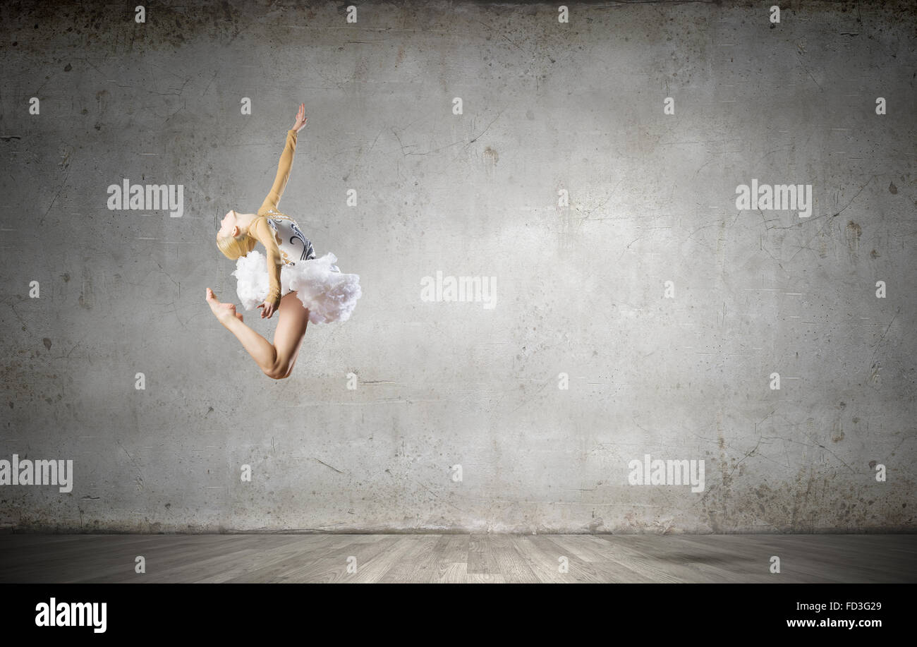 Young pretty ballerina girl making jump in dance Stock Photo - Alamy