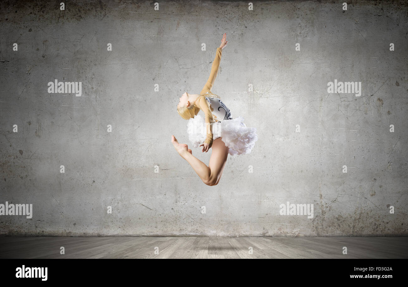 Young pretty ballerina girl making jump in dance Stock Photo - Alamy