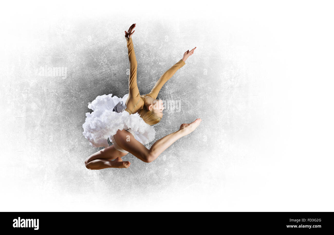 Young pretty ballerina girl making jump in dance Stock Photo - Alamy