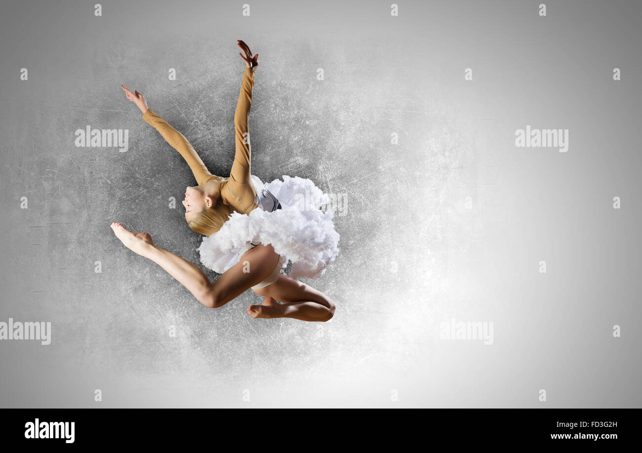 Young pretty ballerina girl making jump in dance Stock Photo - Alamy