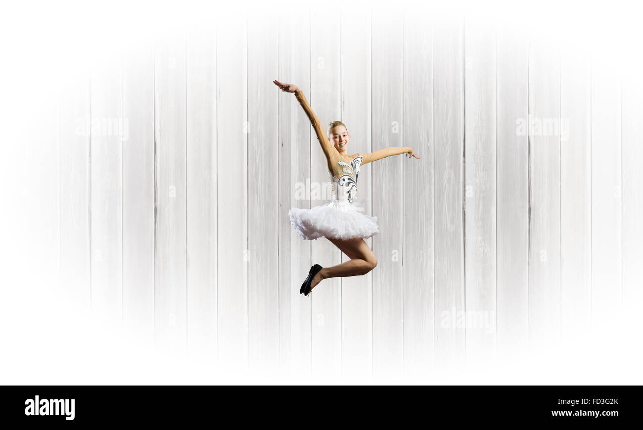 Young pretty ballerina girl making jump in dance Stock Photo - Alamy