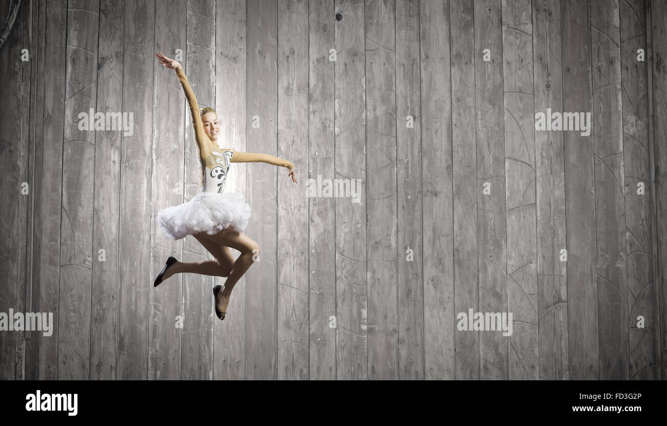 Young pretty ballerina girl making jump in dance Stock Photo - Alamy