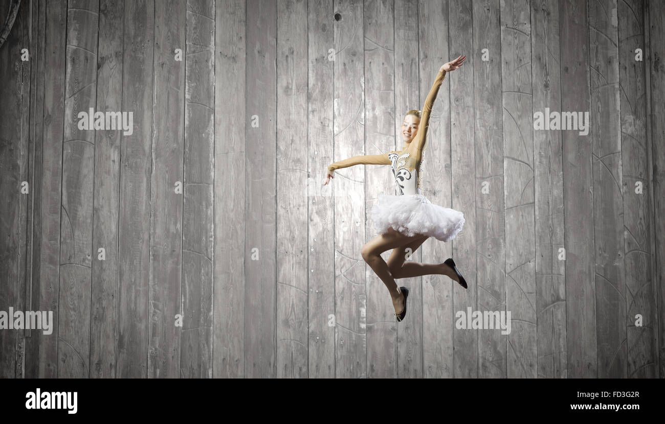 Young pretty ballerina girl making jump in dance Stock Photo - Alamy