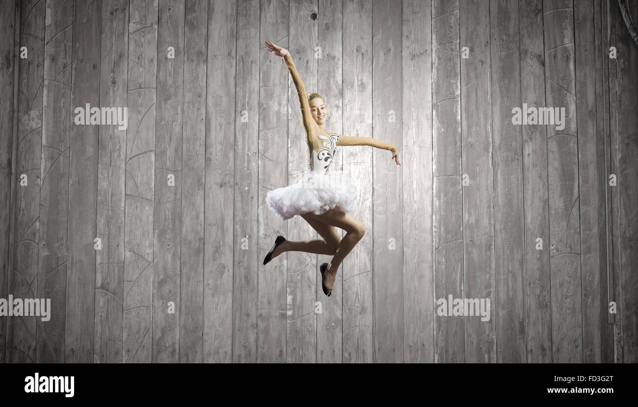 Young pretty ballerina girl making jump in dance Stock Photo - Alamy