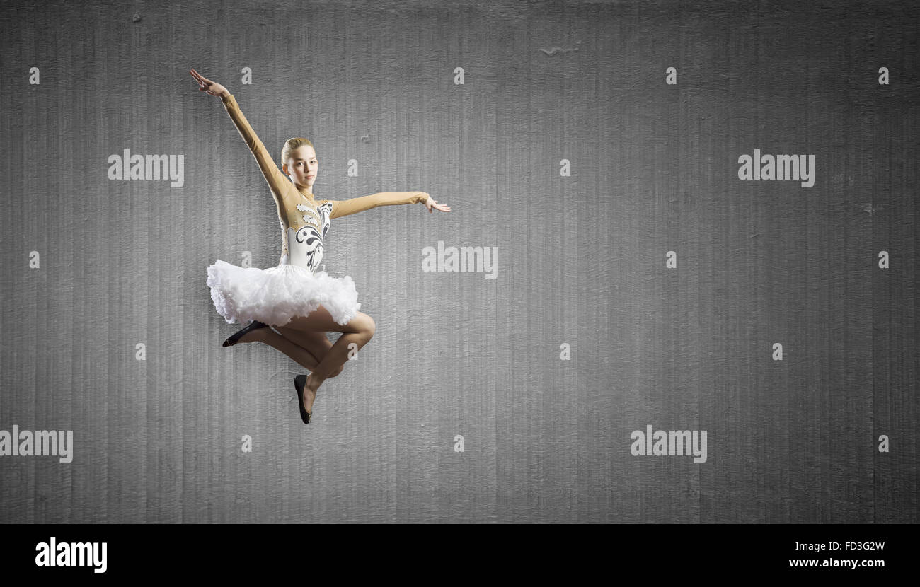 Young pretty ballerina girl making jump in dance Stock Photo - Alamy