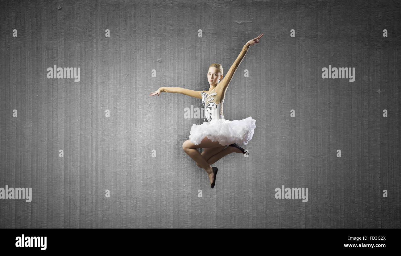 Young pretty ballerina girl making jump in dance Stock Photo - Alamy