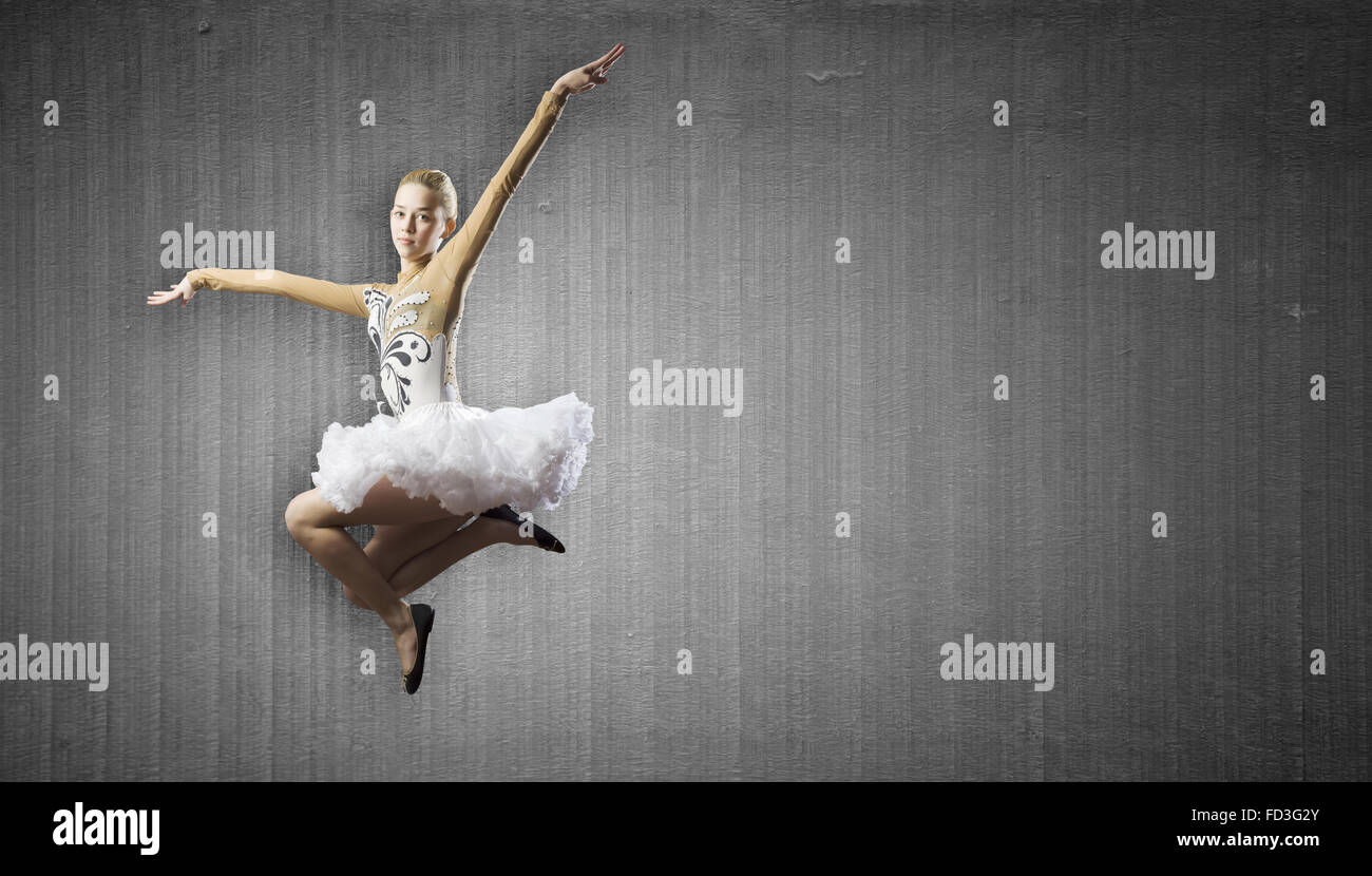 Young pretty ballerina girl making jump in dance Stock Photo - Alamy