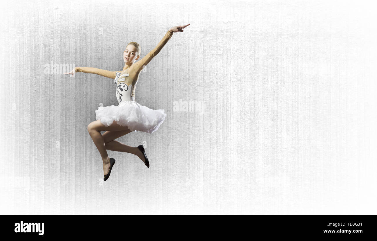 Young pretty ballerina girl making jump in dance Stock Photo - Alamy