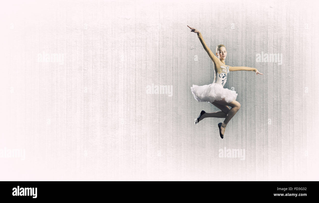Young pretty ballerina girl making jump in dance Stock Photo - Alamy