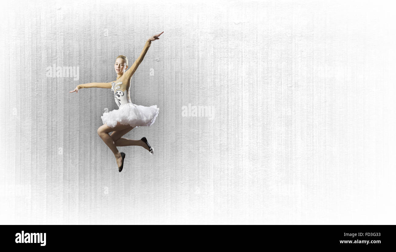 Young pretty ballerina girl making jump in dance Stock Photo - Alamy