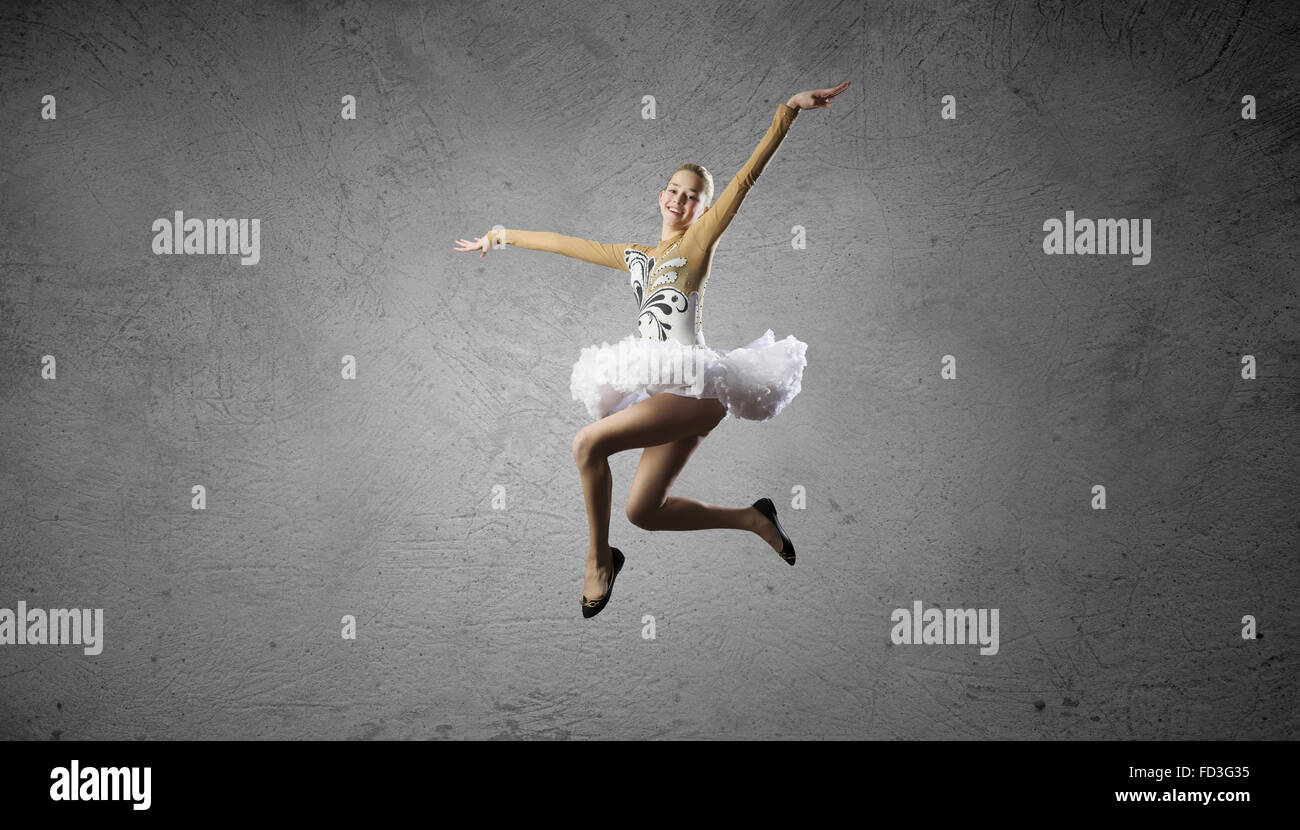 Young pretty ballerina girl making jump in dance Stock Photo - Alamy
