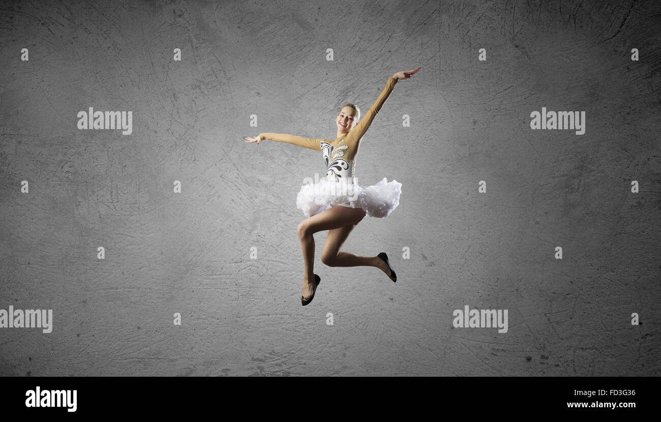Young pretty ballerina girl making jump in dance Stock Photo - Alamy