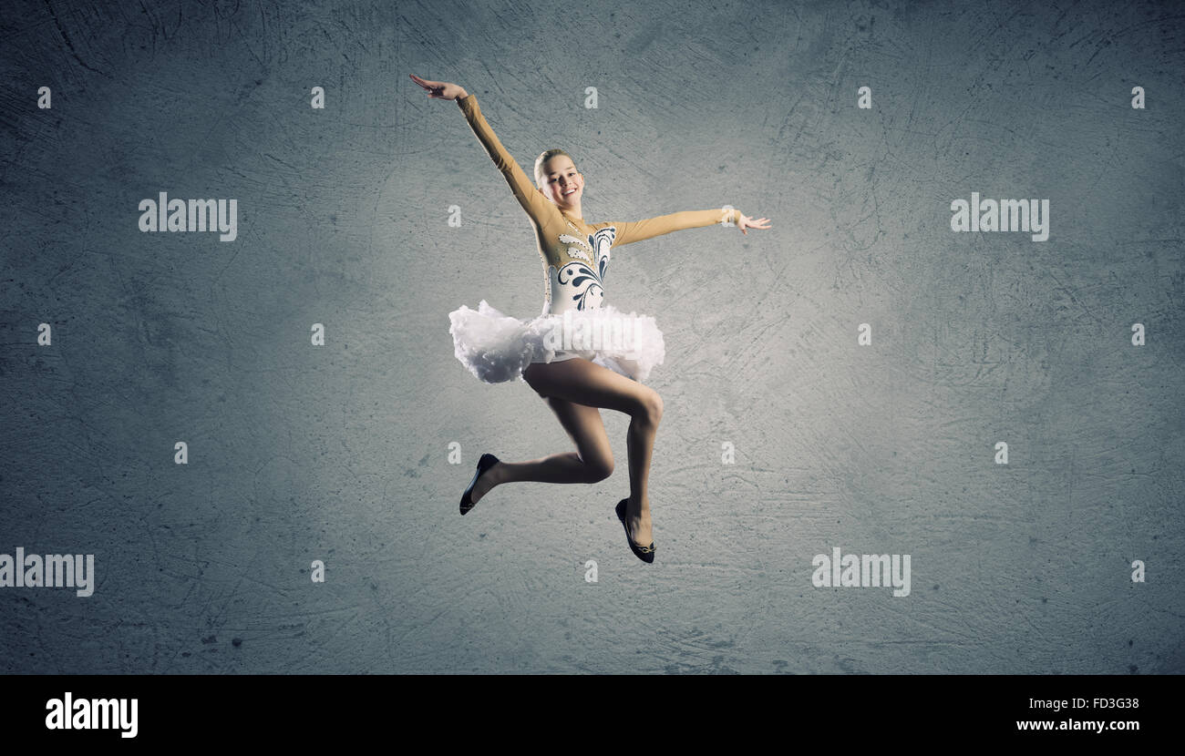 Young pretty ballerina girl making jump in dance Stock Photo - Alamy