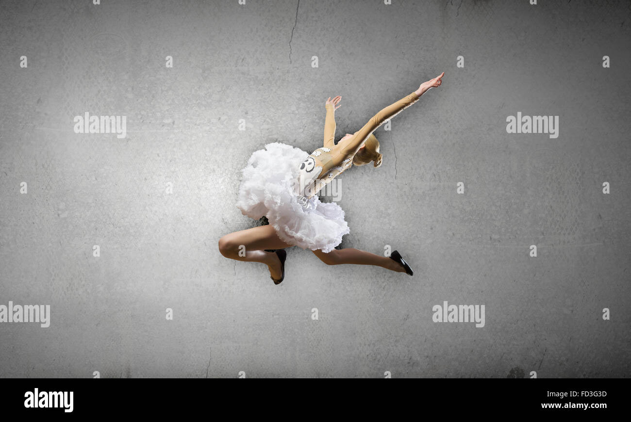 Young pretty ballerina girl making jump in dance Stock Photo - Alamy