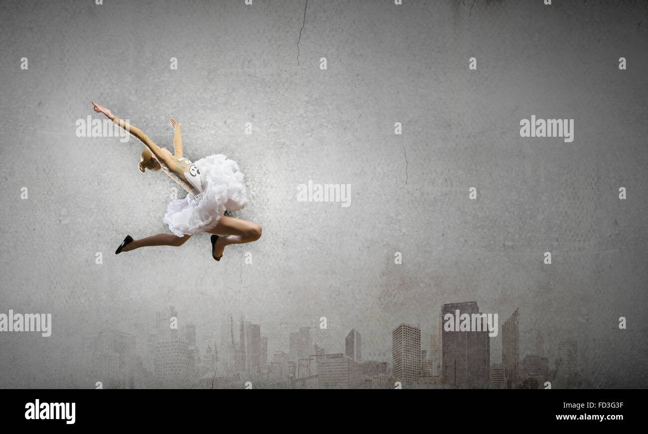 Young pretty ballerina girl making jump in dance Stock Photo - Alamy