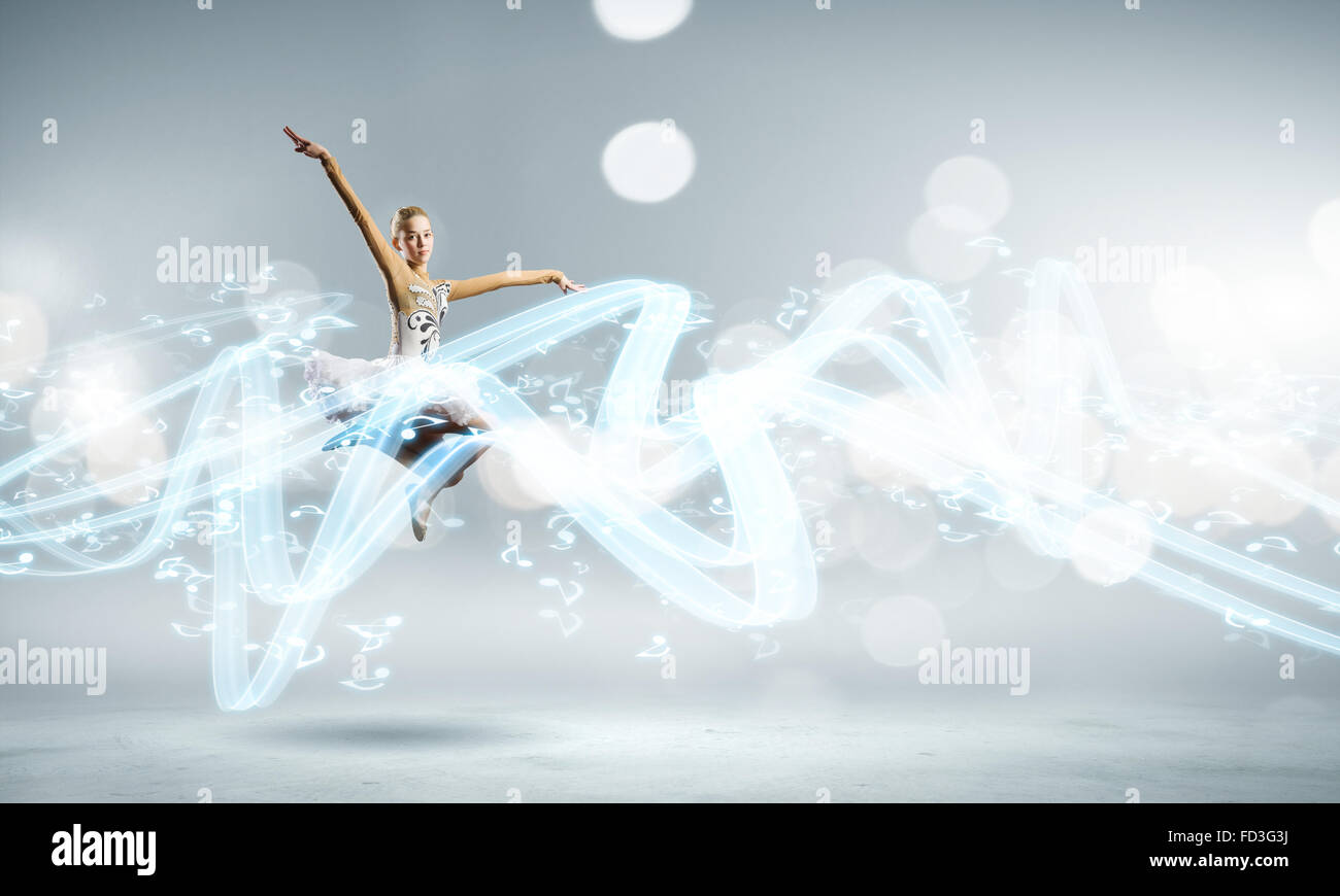 Young pretty ballerina girl making jump in dance Stock Photo - Alamy