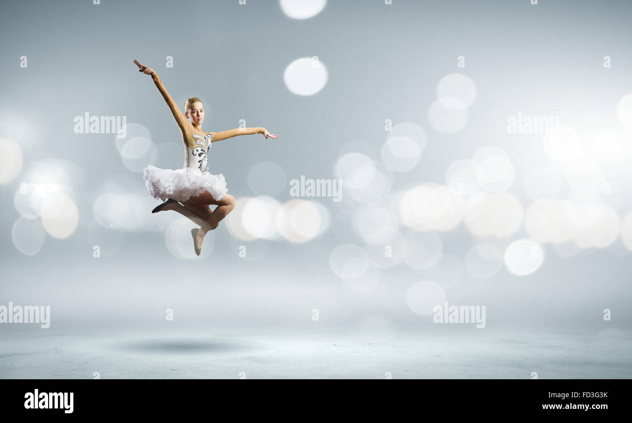 Young pretty ballerina girl making jump in dance Stock Photo - Alamy