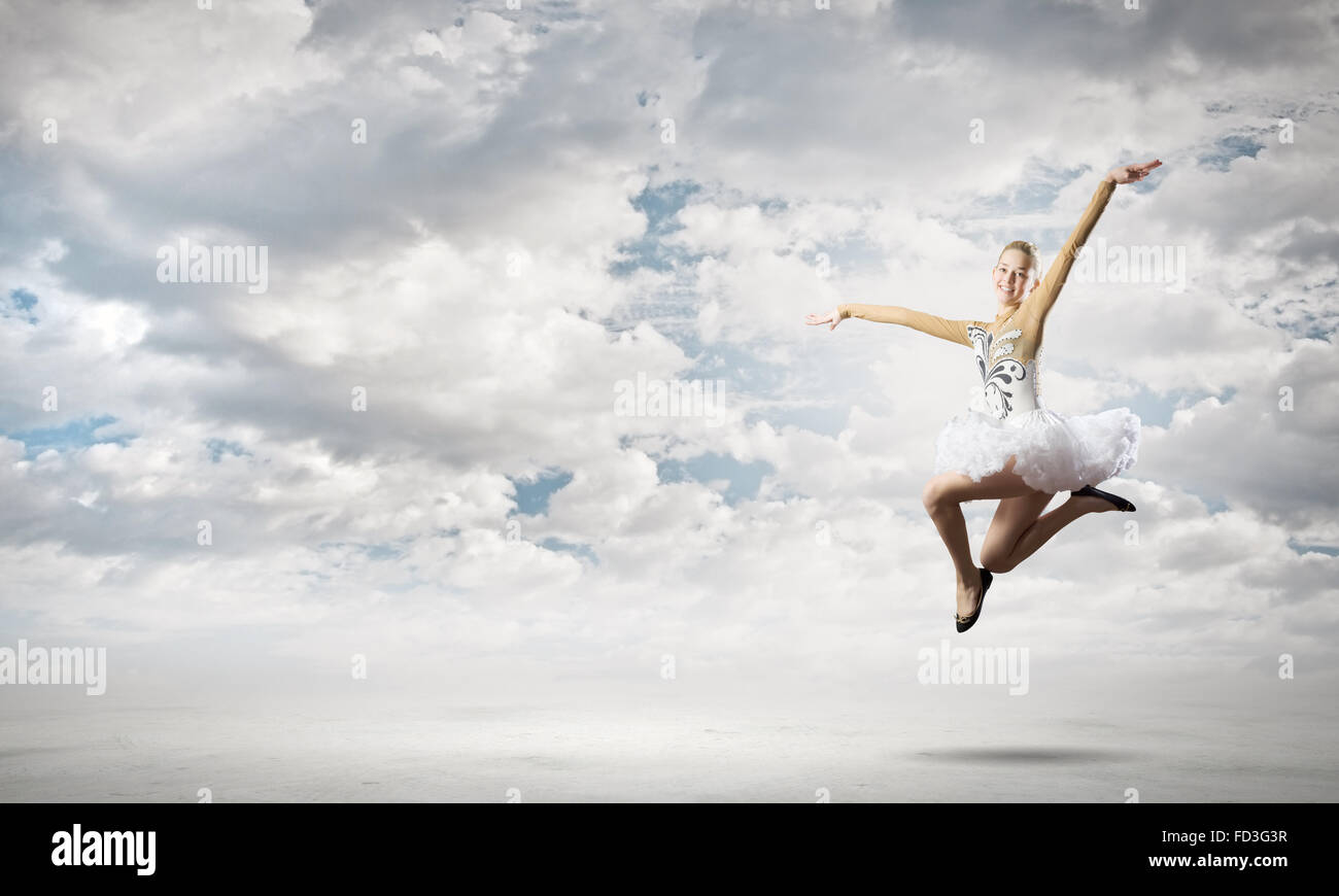 Young pretty ballerina girl making jump in dance Stock Photo - Alamy