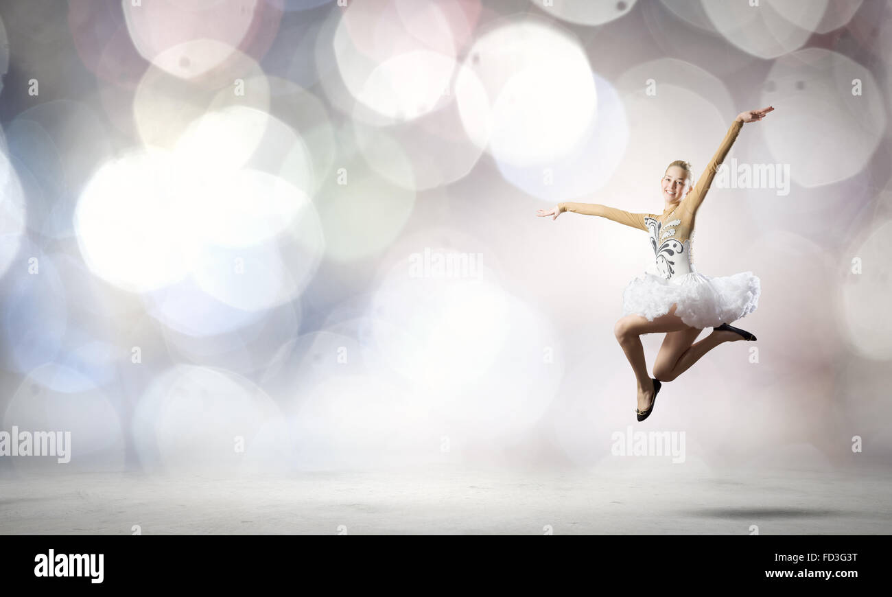 Young pretty ballerina girl making jump in dance Stock Photo - Alamy