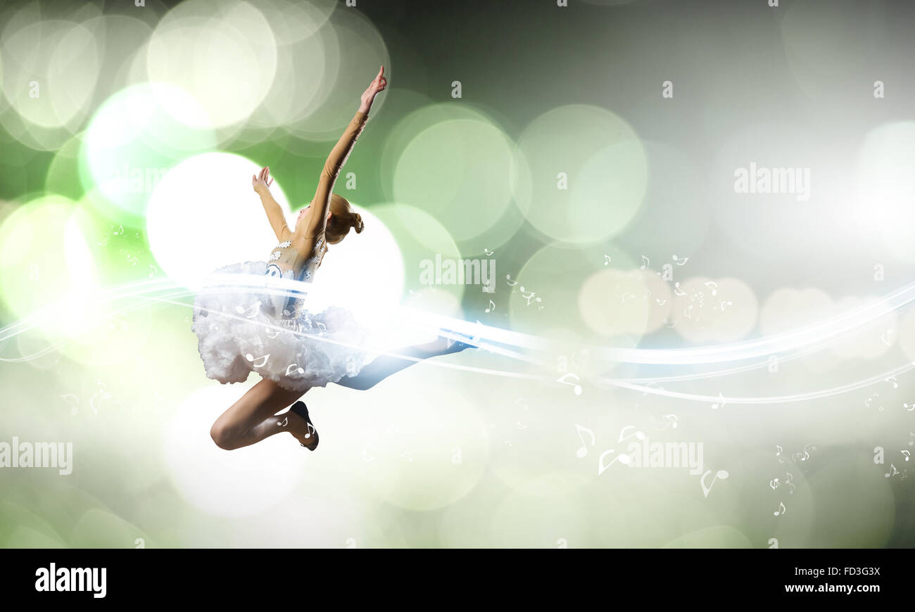 Young pretty ballerina girl making jump in dance Stock Photo - Alamy