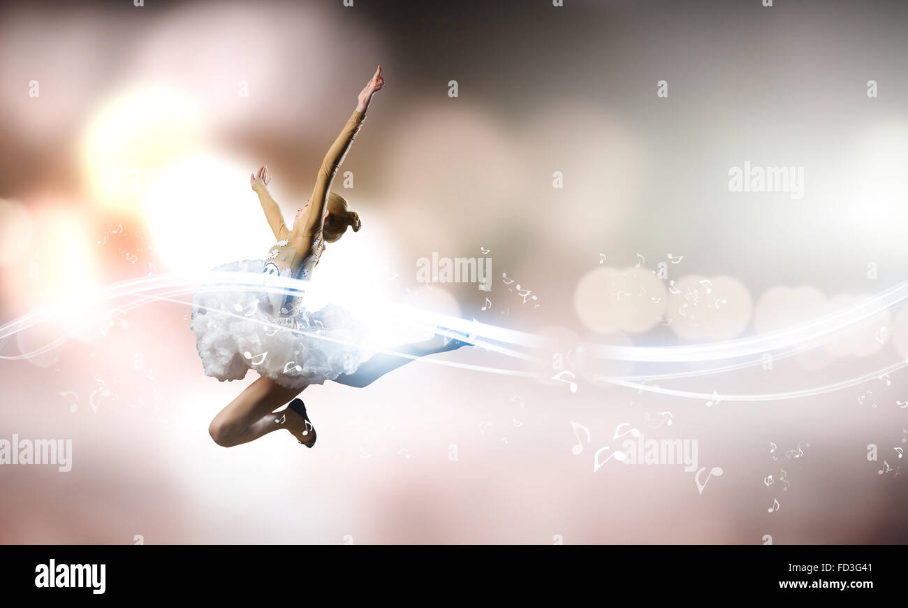 Young pretty ballerina girl making jump in dance Stock Photo - Alamy