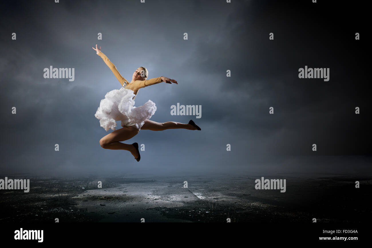 Young pretty ballerina girl making jump in dance Stock Photo - Alamy