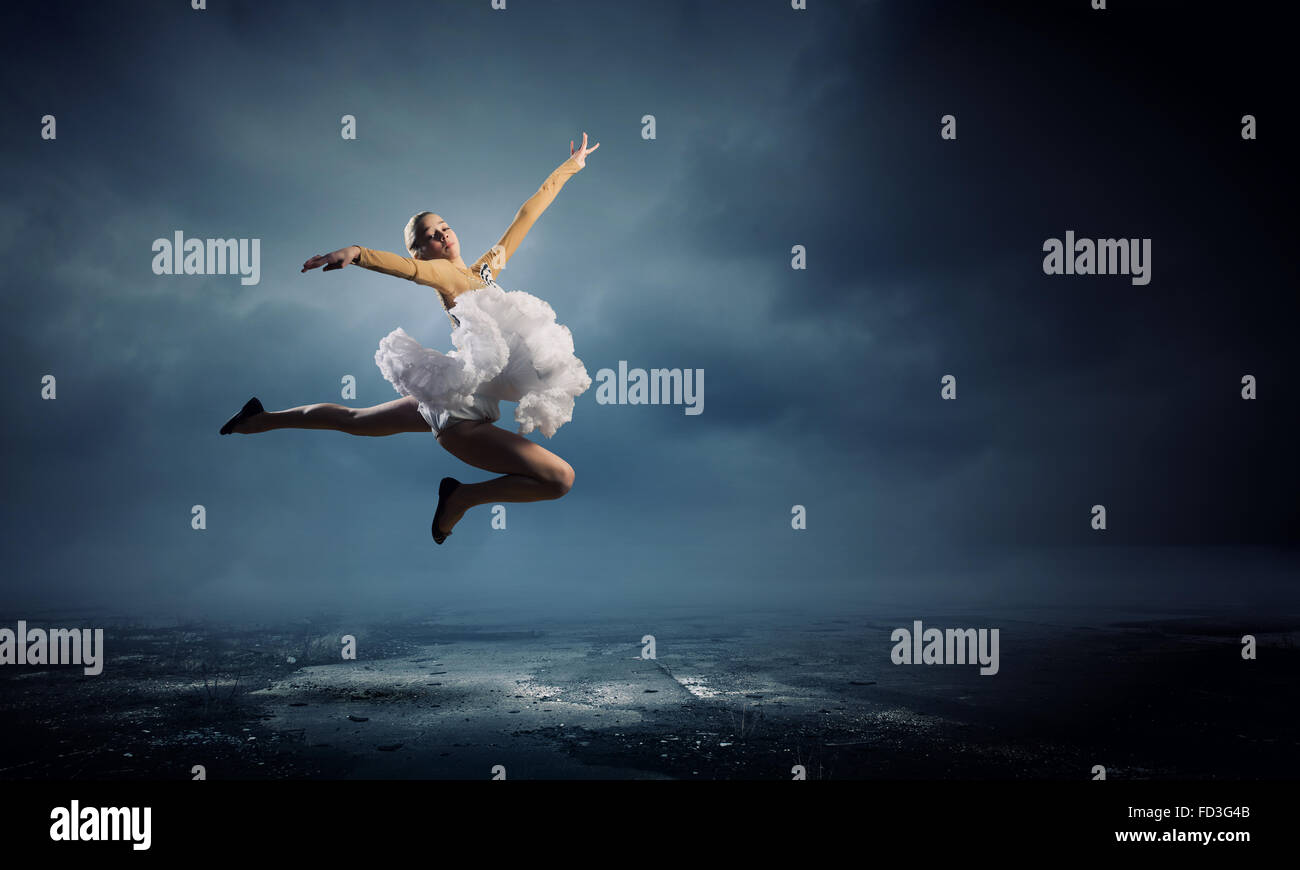 Young pretty ballerina girl making jump in dance Stock Photo - Alamy