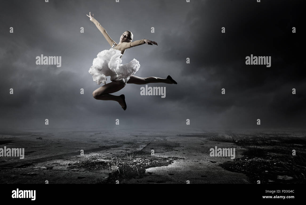 Young pretty ballerina girl making jump in dance Stock Photo - Alamy