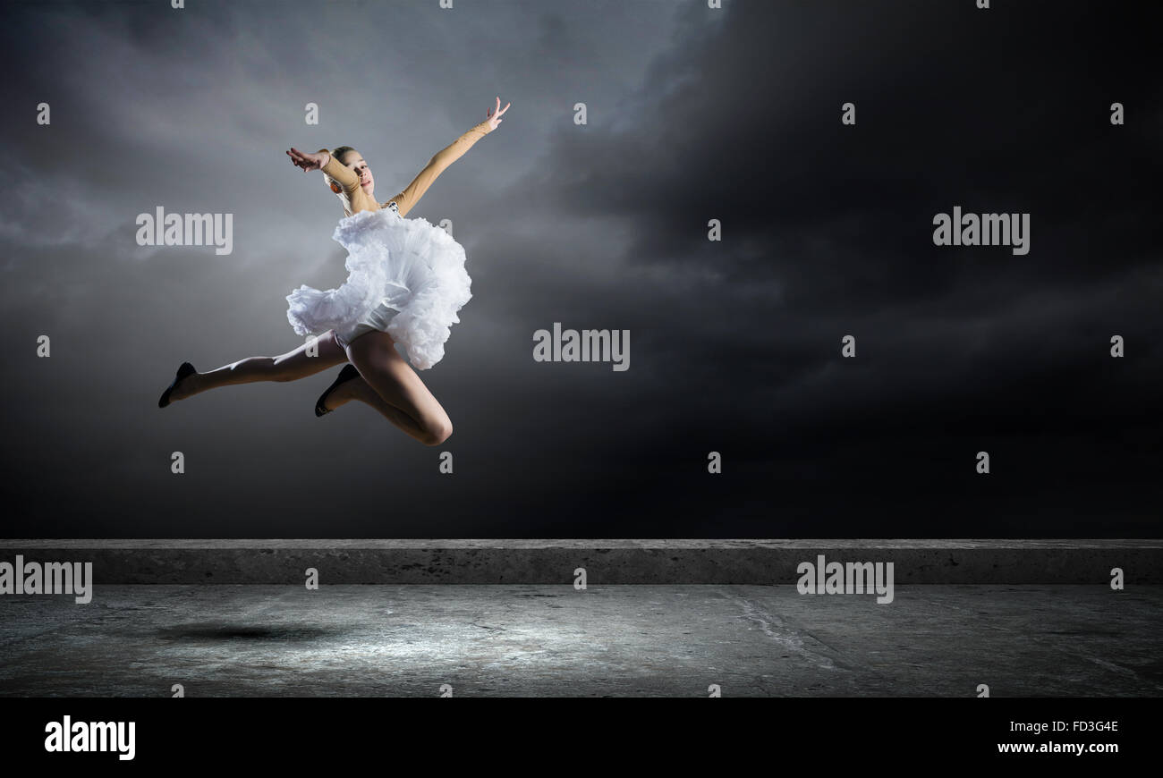 Young pretty ballerina girl making jump in dance Stock Photo - Alamy