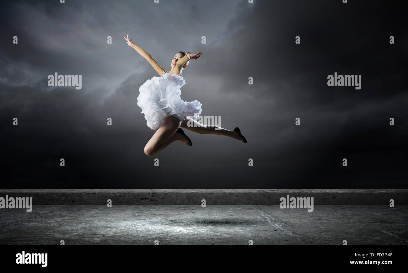 Young pretty ballerina girl making jump in dance Stock Photo - Alamy
