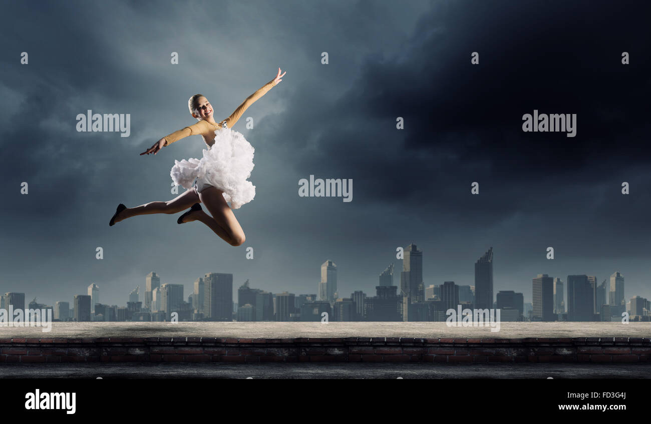 Young pretty ballerina girl making jump in dance Stock Photo - Alamy