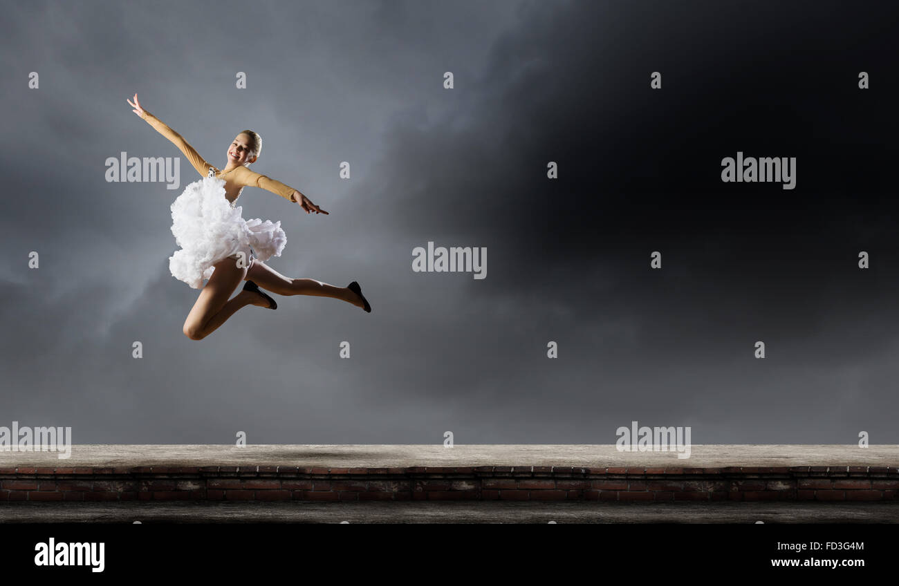 Young pretty ballerina girl making jump in dance Stock Photo - Alamy