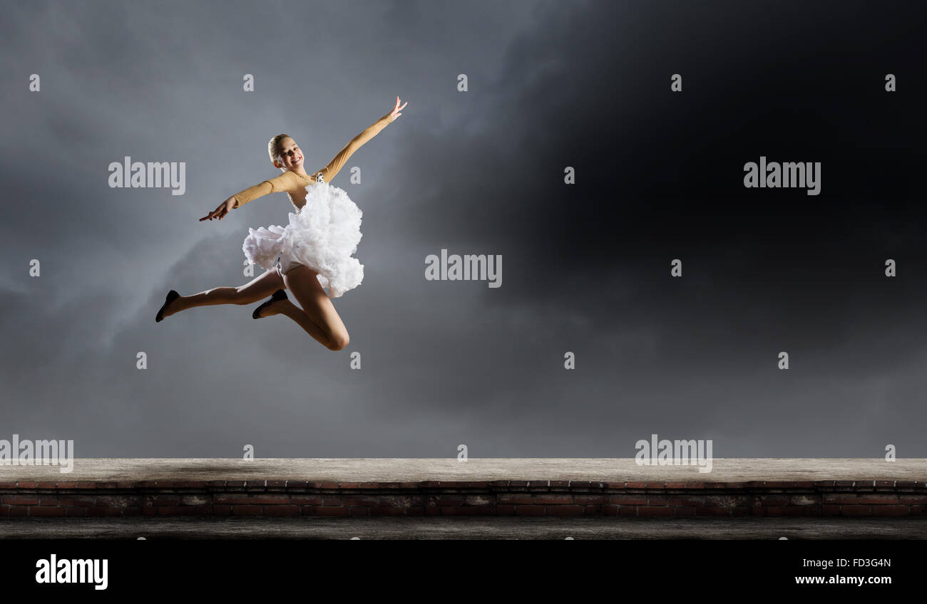 Young pretty ballerina girl making jump in dance Stock Photo - Alamy