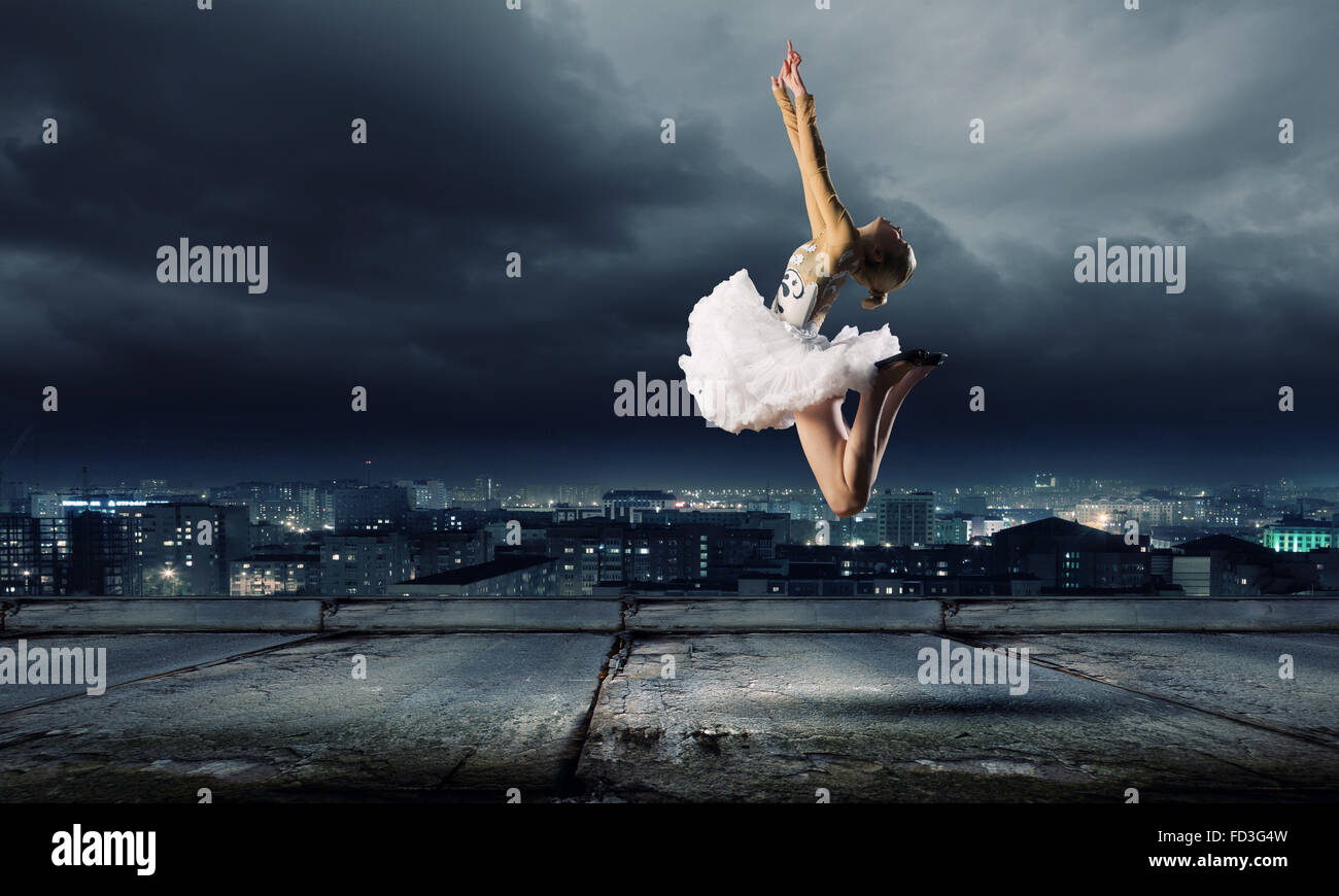 Young pretty ballerina girl making jump in dance Stock Photo - Alamy